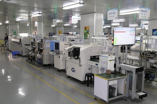 What does the SMT manufacturing shop in the electronics factory do?